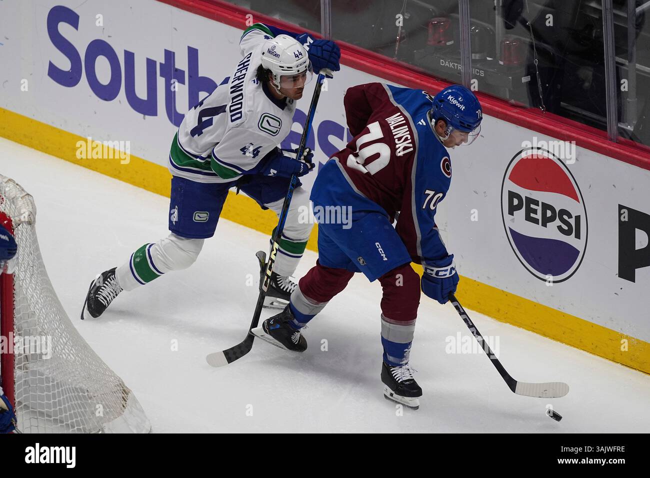 Vancouver Canucks left wing Kiefer Sherwood (44) and Colorado Avalanche ...