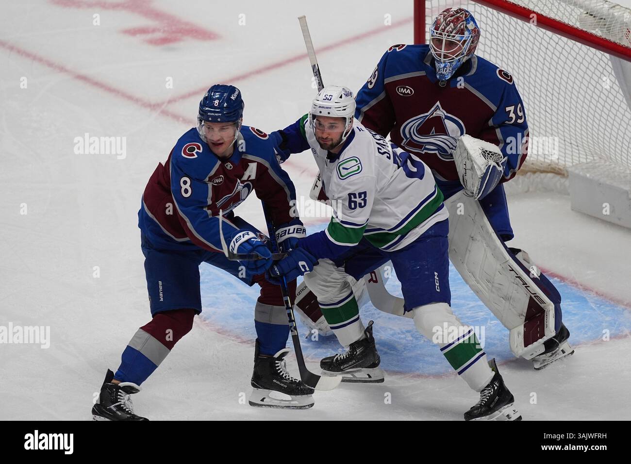 Vancouver Canucks center Max Sasson (63) jostles for position between ...