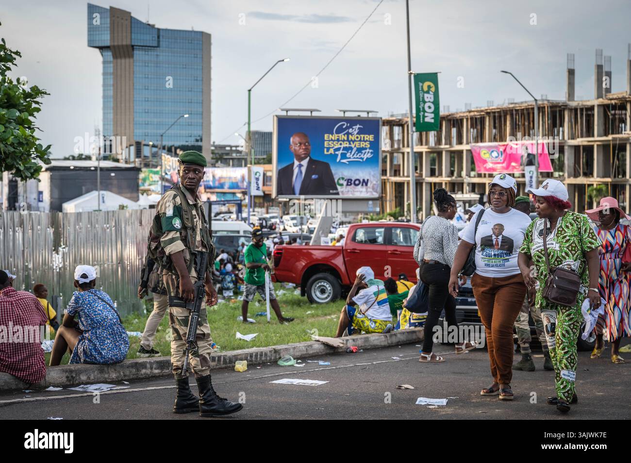 Libreville, Gabon. 10th Apr, 2025. People are seen near a campaign sign in Libreville, Gabon, on ...