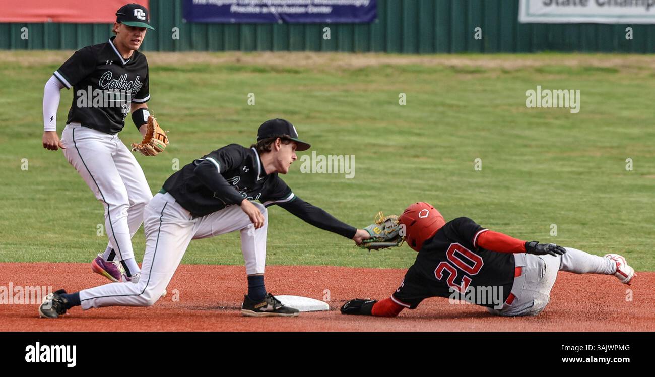Owensboro Catholic's Mason Moser, center, tags out Daviess County's ...
