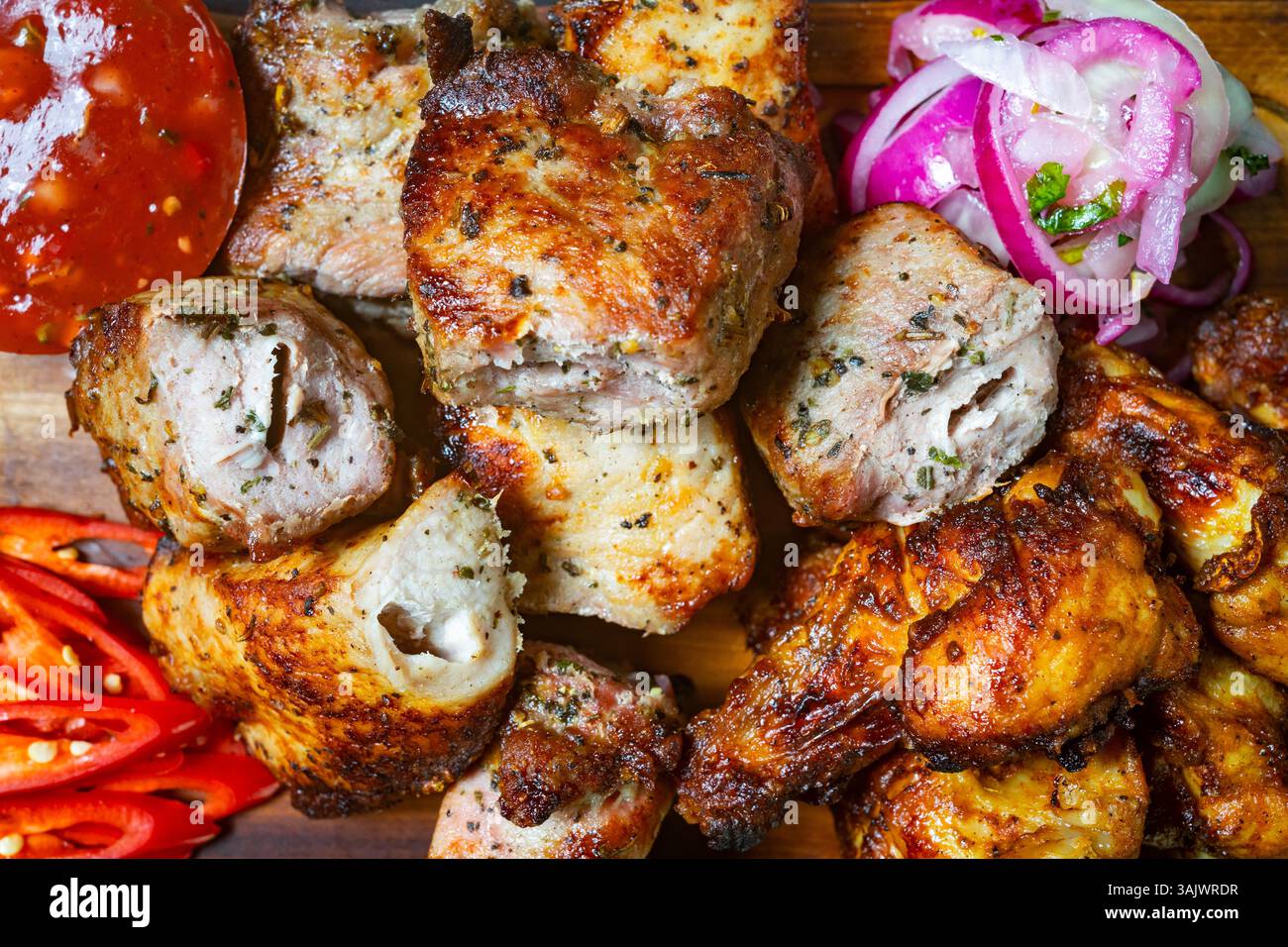 A variety of grilled meats is displayed, including tender chicken and ...