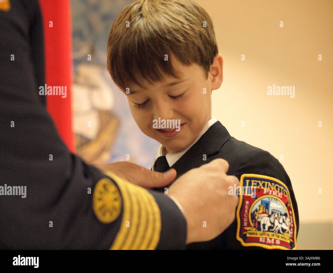 Lexington Fire Chief Bob Hendricks (just arm showing) pinned the Junior ...