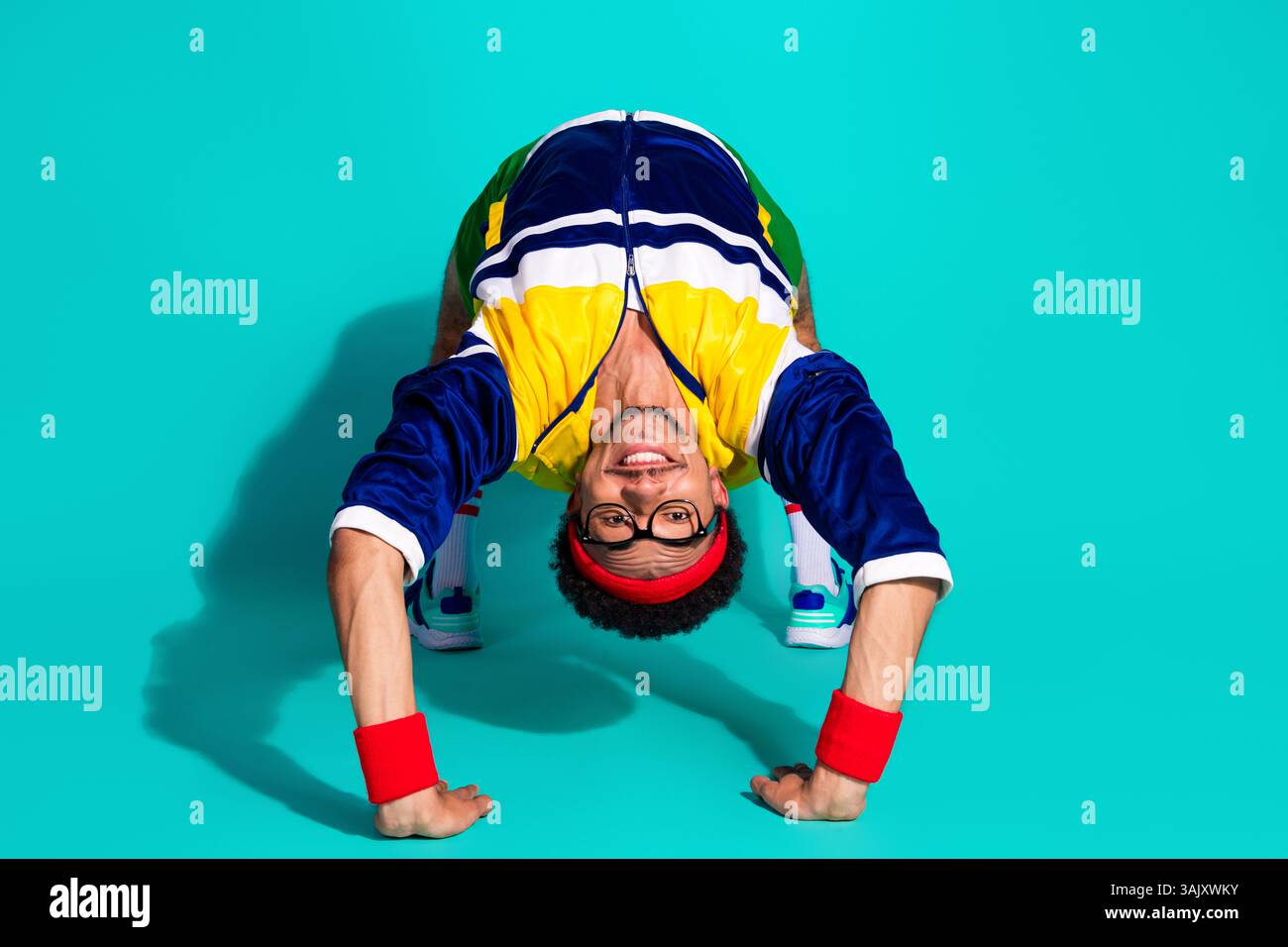 Energetic young man in retro sportswear leaning backwards in a creative ...