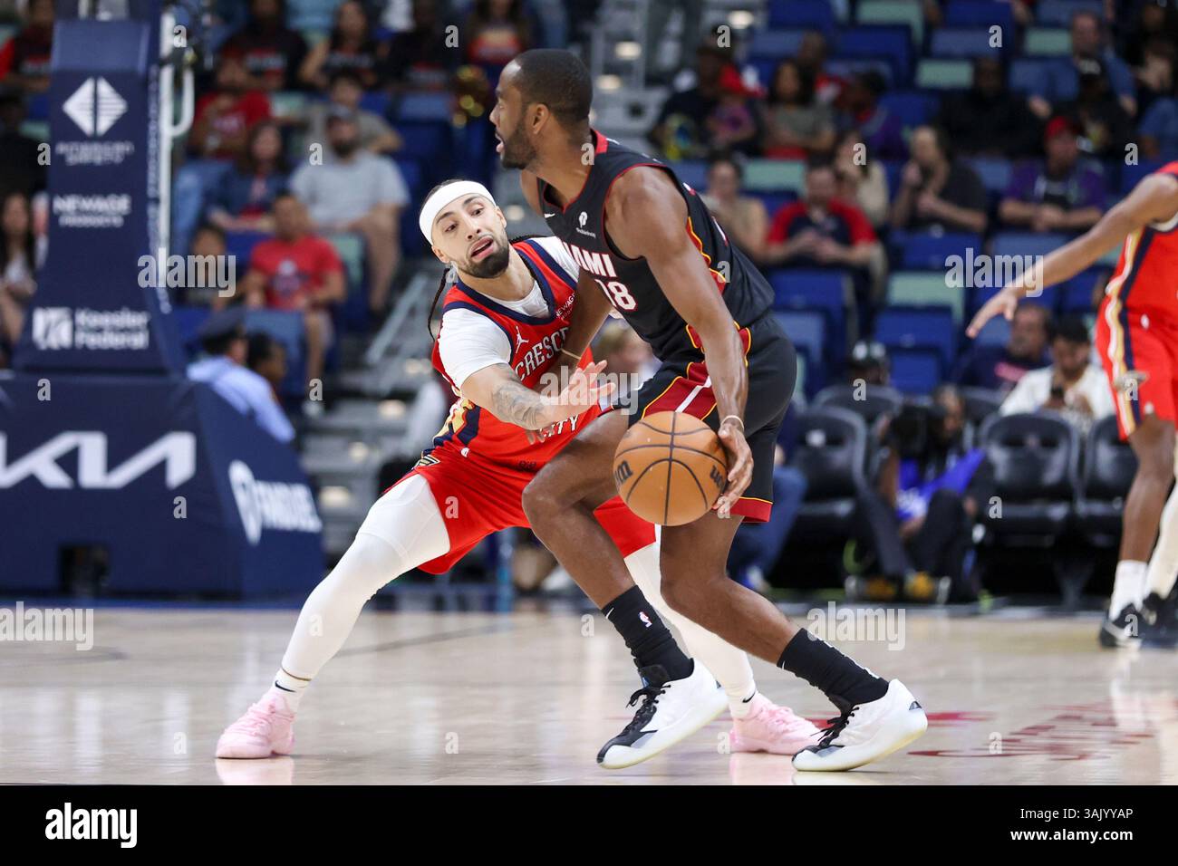 New Orleans Pelicans guard Jose Alvarado, left, tries to steal the ball ...