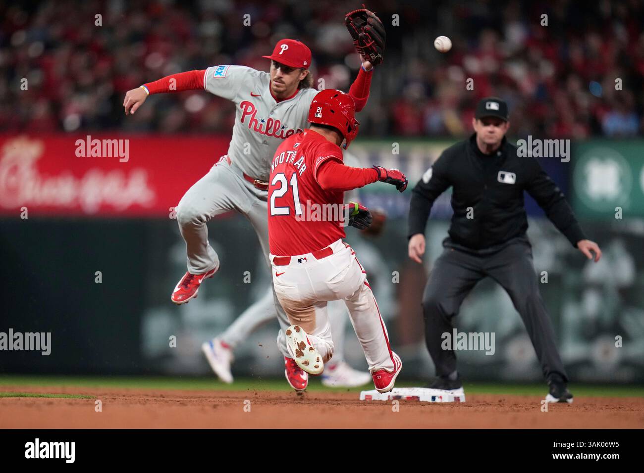 St. Louis Cardinals' Lars Nootbaar (21) steals second as the throw gets ...