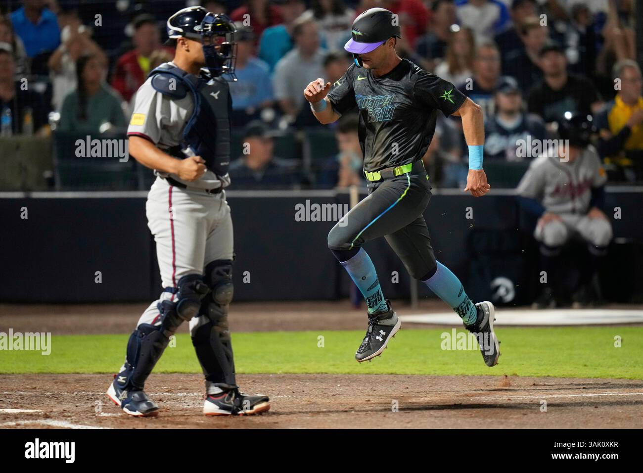 Tampa Bay Rays' Kameron Misner, right, scores in front of Atlanta ...