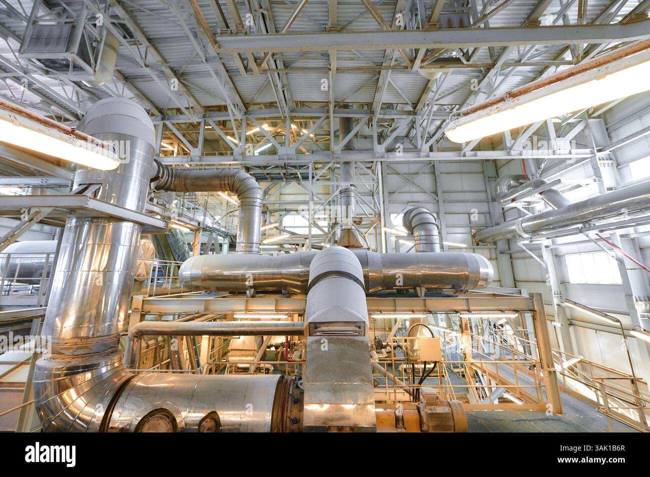 Chemical plant interior showcasing extensive pipelines and conveyors ...