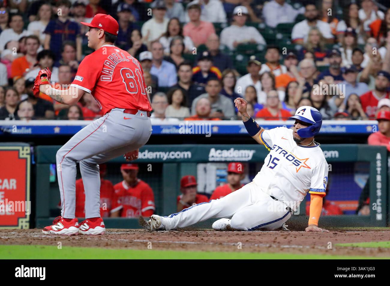 Houston Astros' Isaac Paredes (15) scores on a passed ball as Los ...