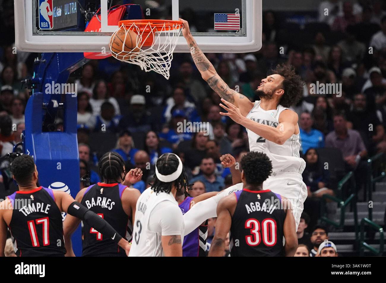Dallas Mavericks' Dereck Lively II dunks as Toronto Raptors' Garrett ...