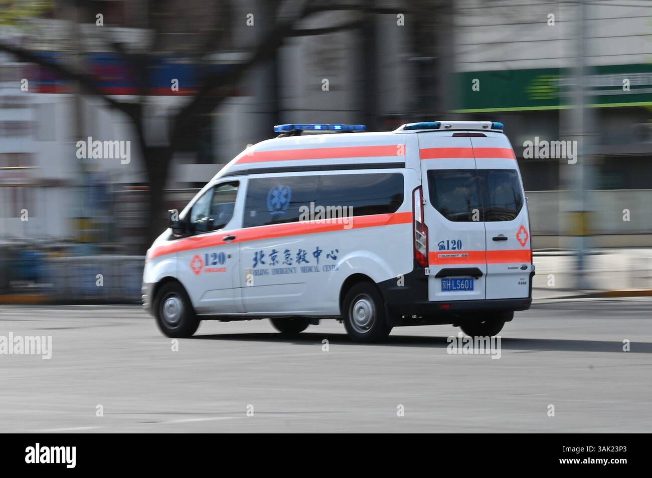Peking, China. 12th Apr, 2025. A Chinese ambulance drives with its blue ...
