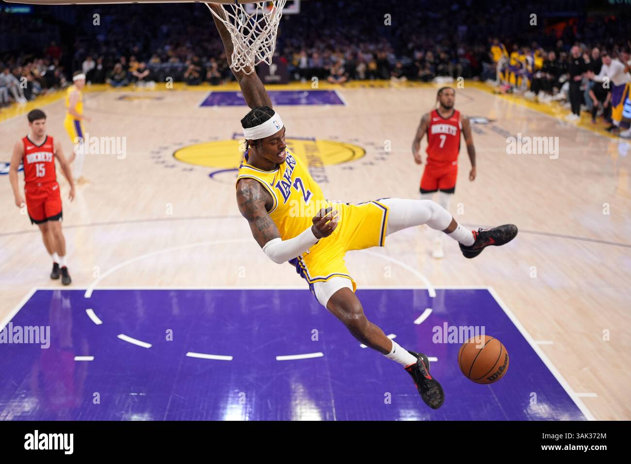 Los Angeles Lakers forward Jarred Vanderbilt, center, dunks as Houston ...