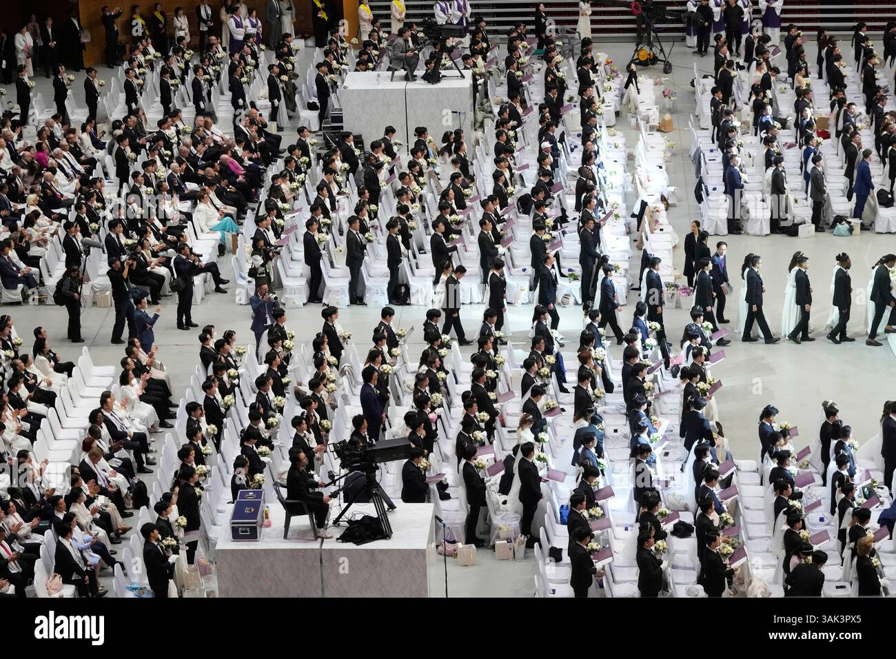 Couples attend a mass wedding ceremony at the Cheong Shim Peace World ...