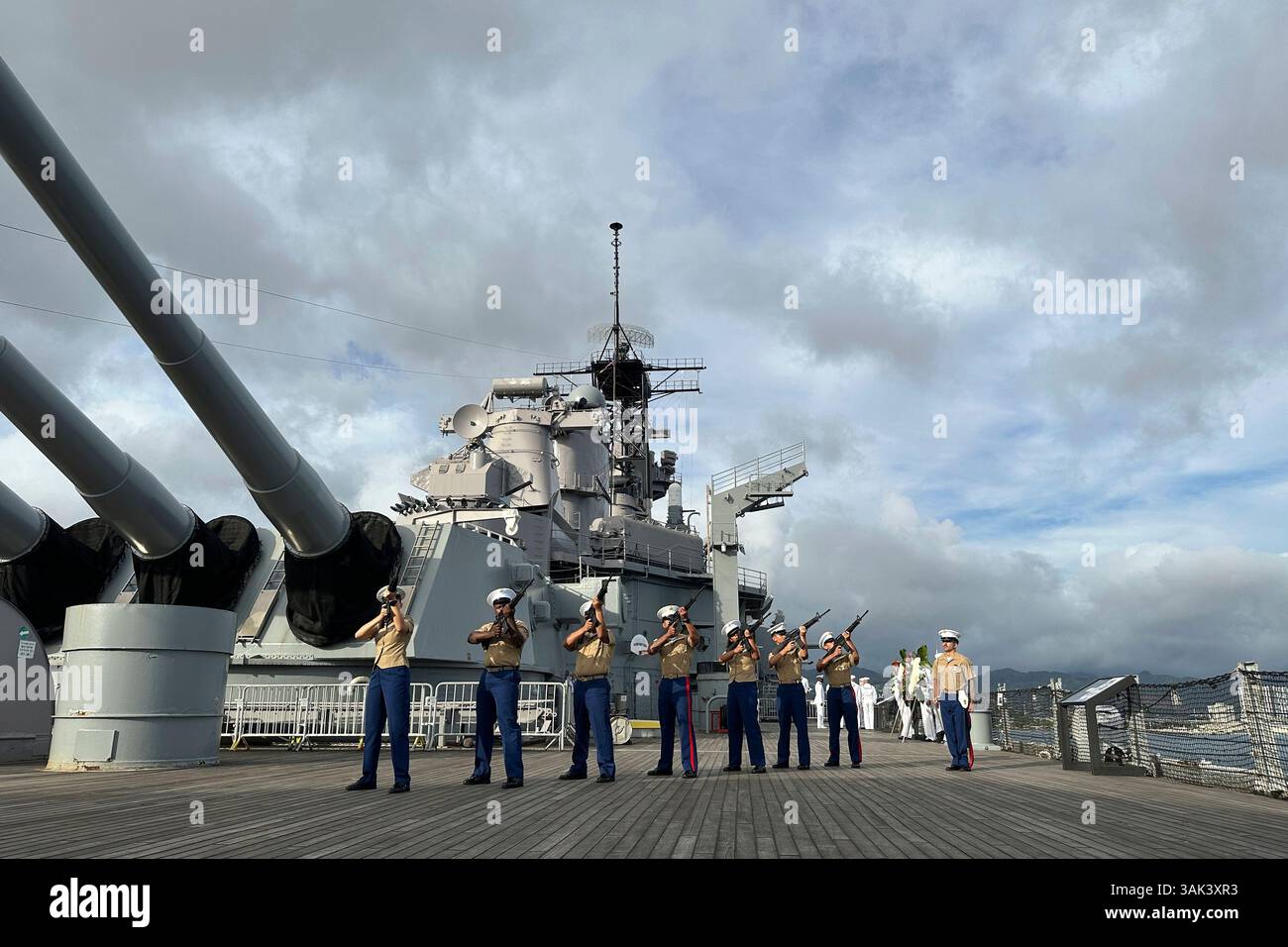 U.S. Marines perform a rifle salute on board the Battleship Missouri ...