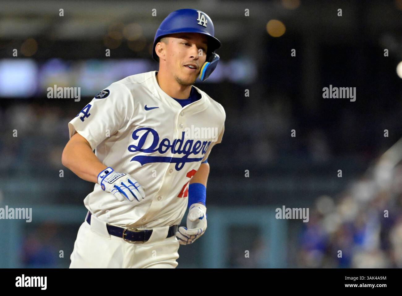 Los Angeles Dodgers' Tommy Edman rounds the bases after hitting a three ...