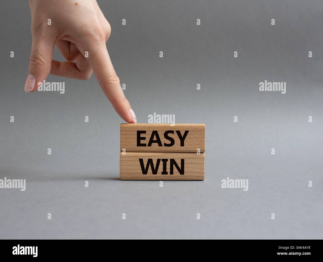Easy win symbol. Wooden blocks with words Easy win. Beautiful grey ...