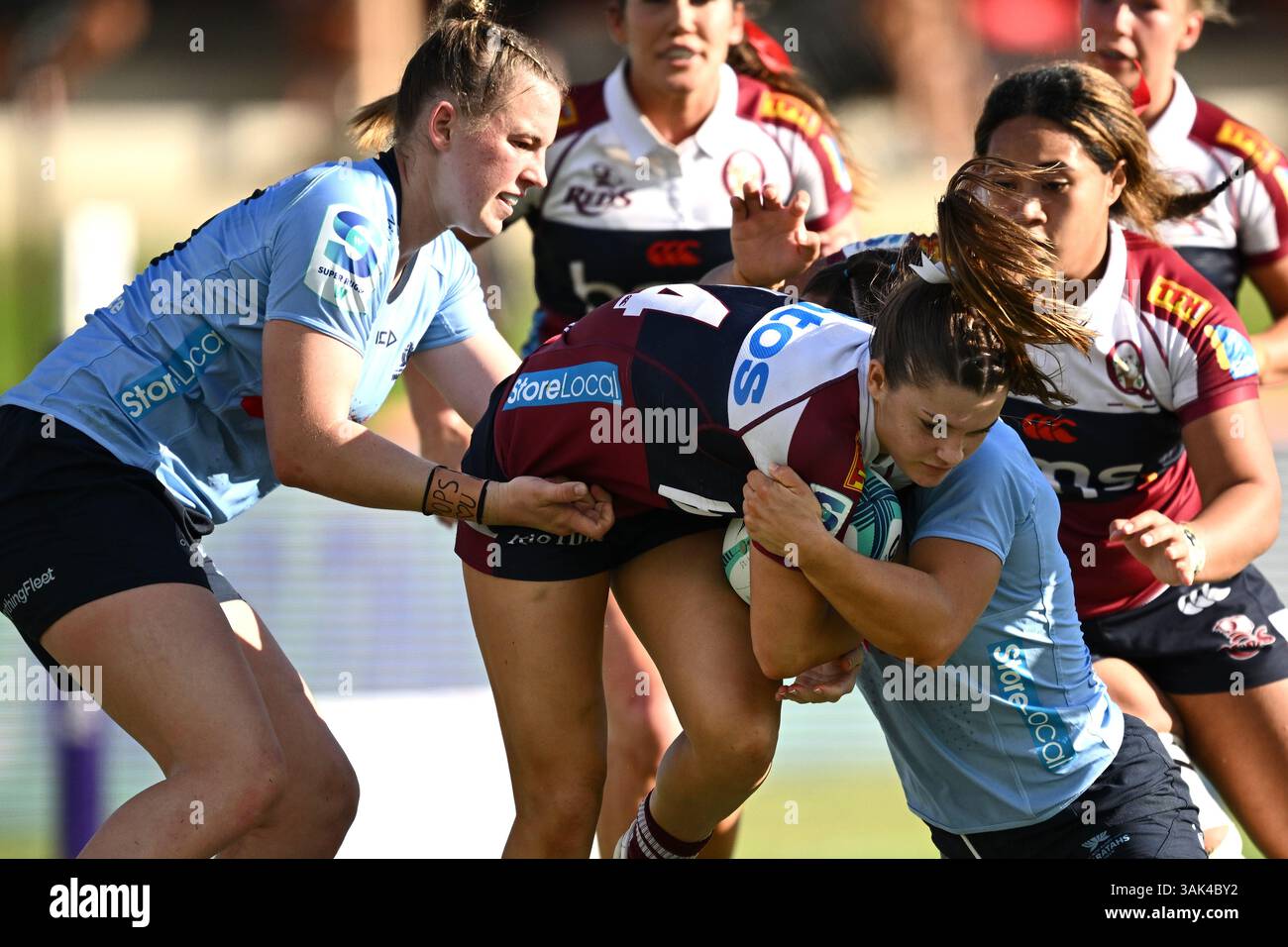 Sydney, Australia. 12th Apr, 2025. Caitlin Urwin of the Reds is tackled ...