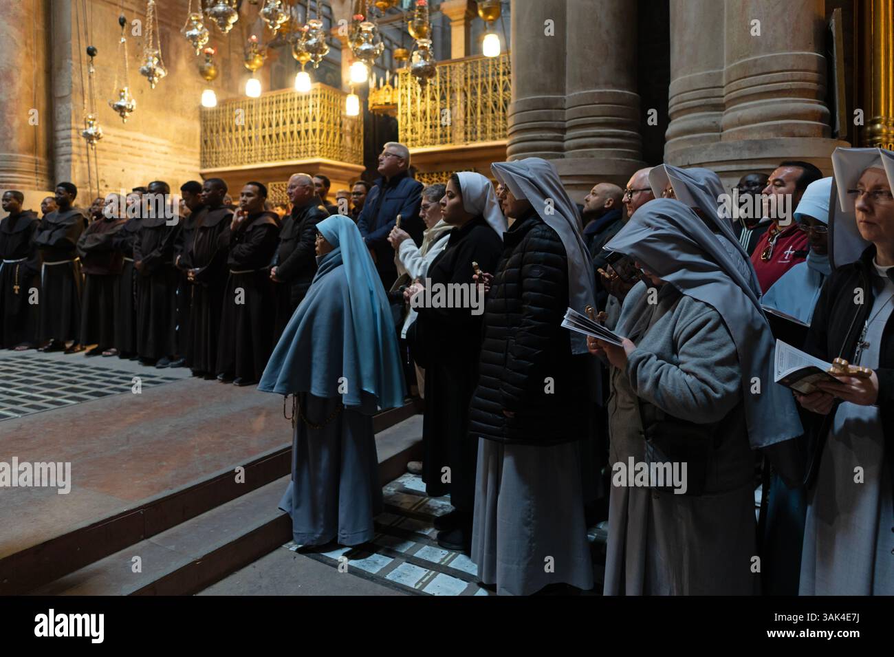 Roman Catholic nuns recite prayers as they take part in a processional ...