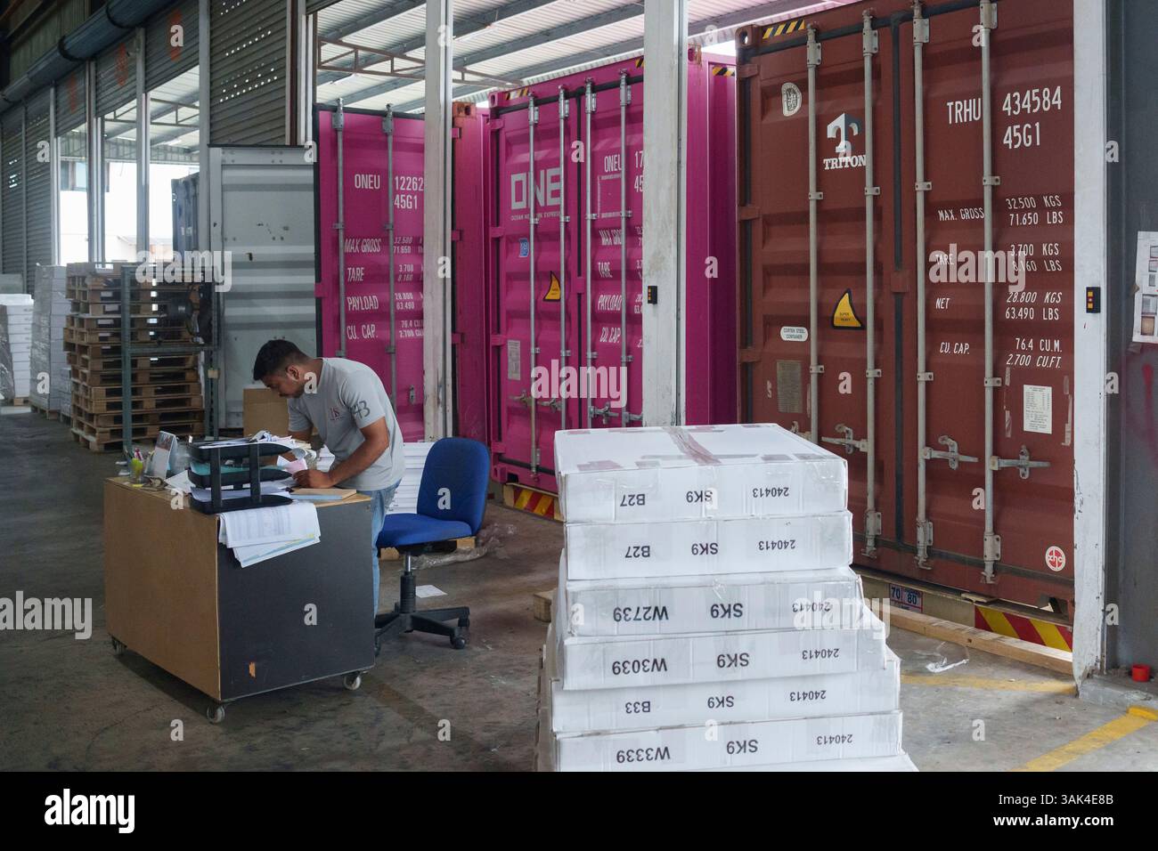 A worker inspects stocks before they are loaded into a container for ...