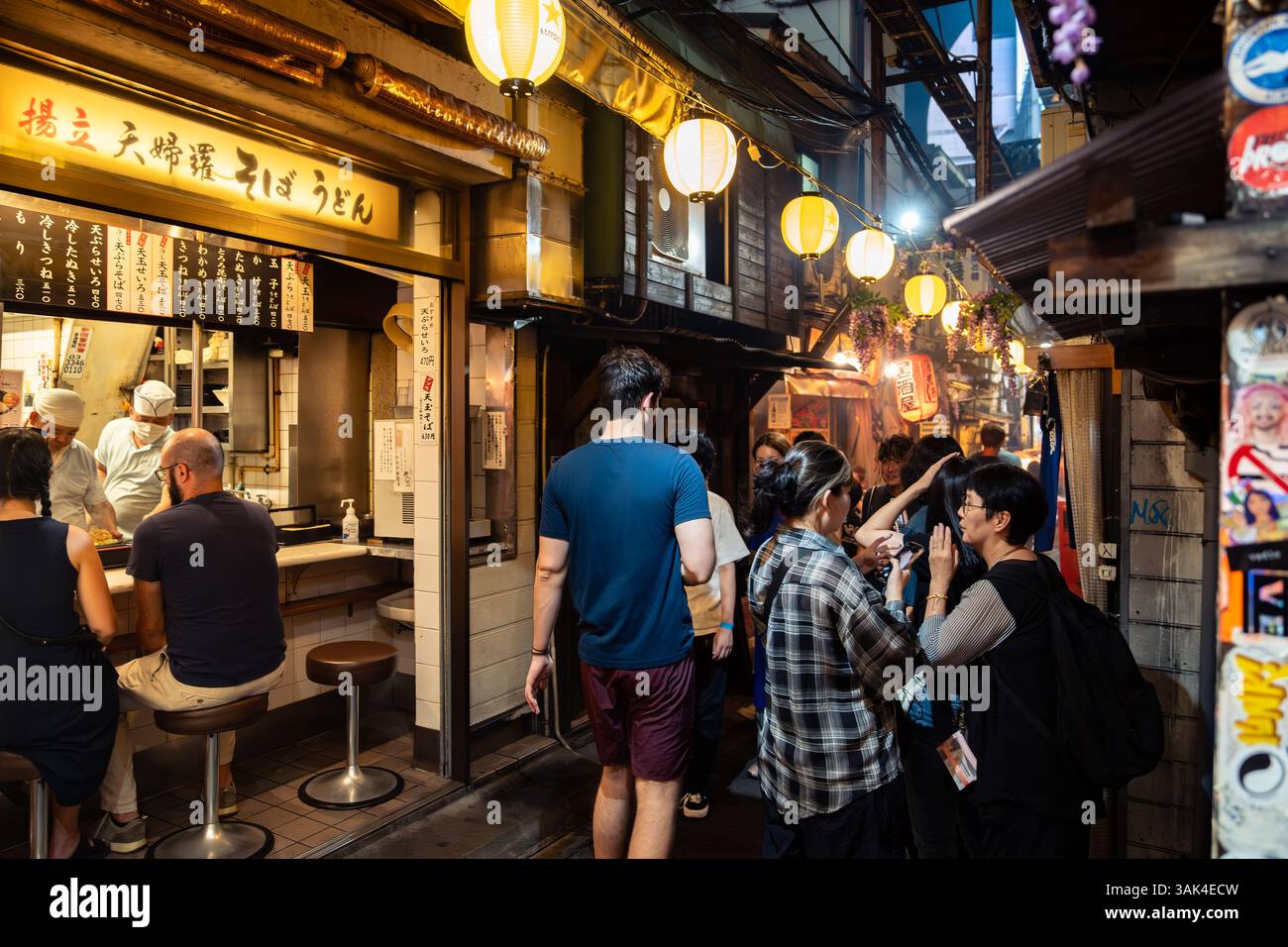 Tokyo, Japan-august 5, 2024:people sit down for dinner in the small ...