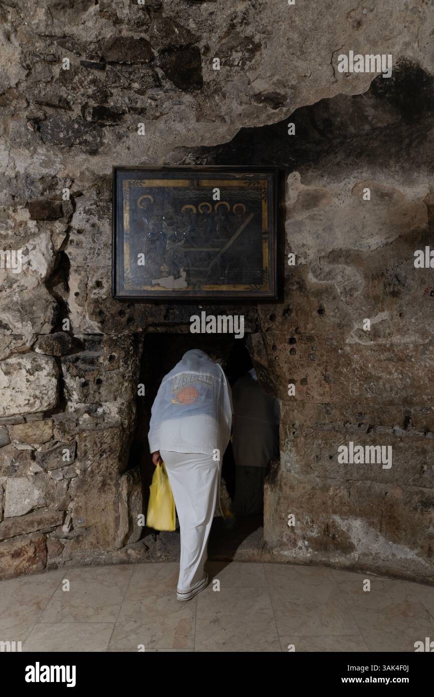 An African pilgrim enters an ancient Jewish rock-cut tomb inside the ...
