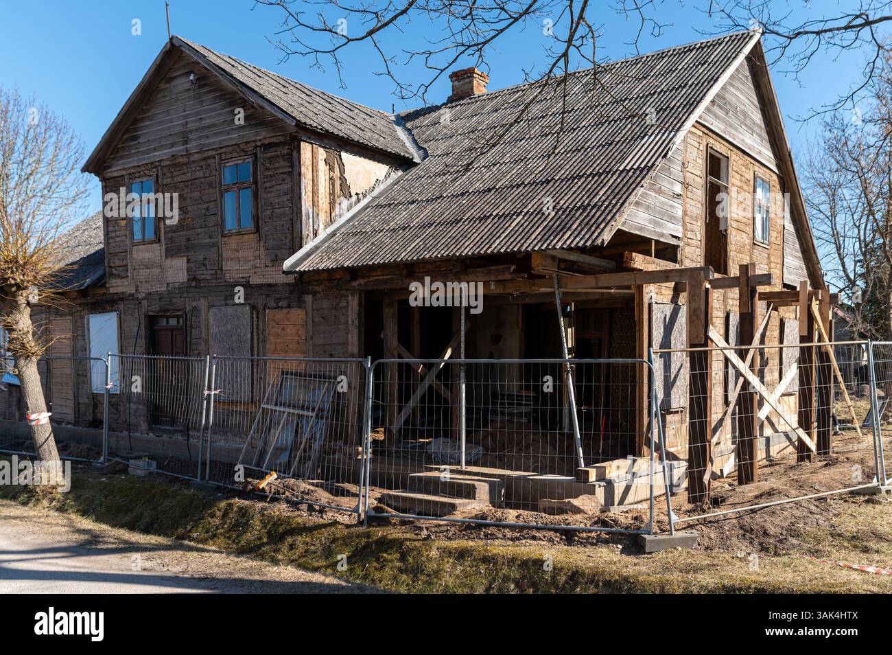 Construction workers restore a historic wooden house in a peaceful ...