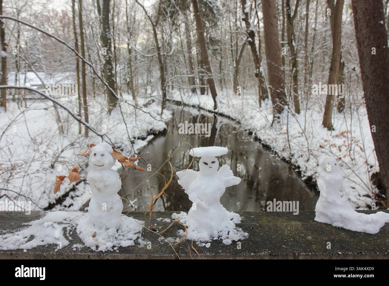 Picture series of funny tiny snow men, built on a romantic bridge ...