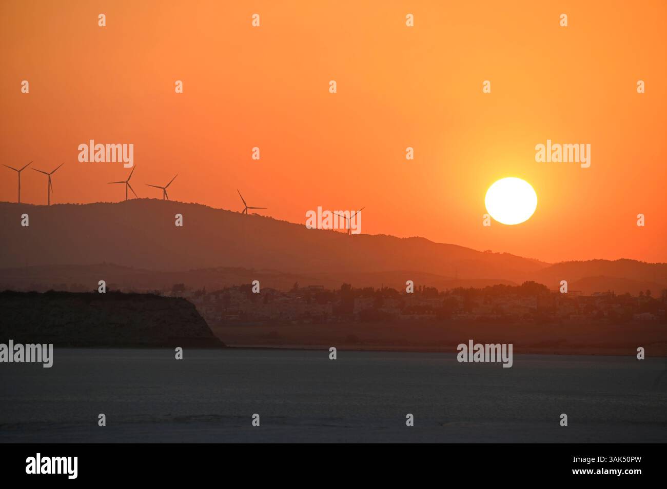 Sunset Over The Salt Lake Of Larnaca Cyprus With Wind Turbines On The ...