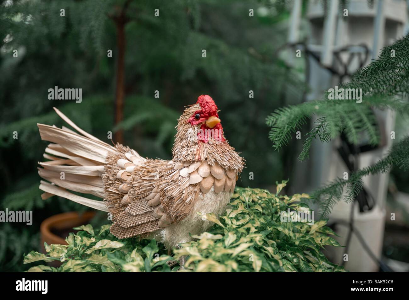 Handmade decorative chicken figure in garden setting. Spring and Easter ...