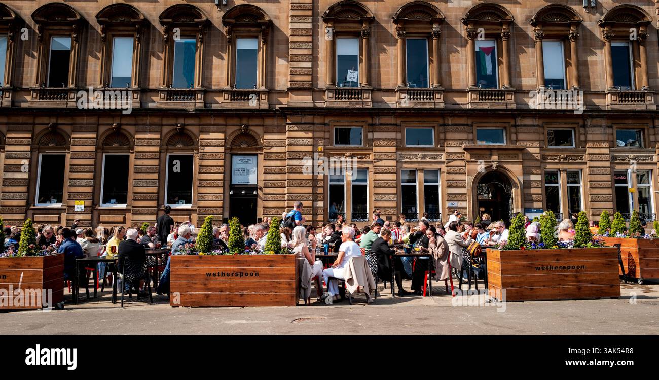 People enjoying spring sunshine in George Square, Glasgow Scotland ...