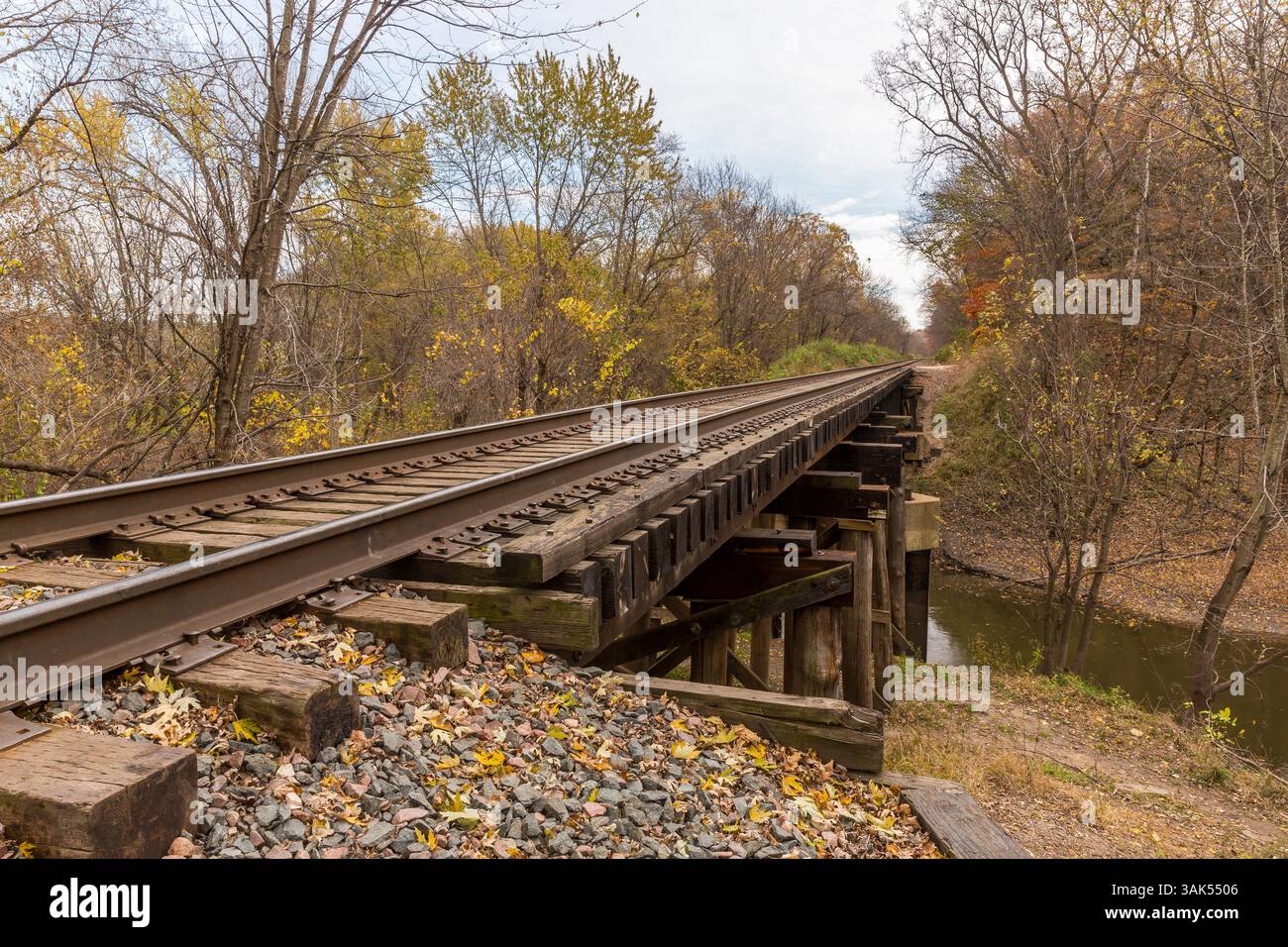 A railroad bridge in the woods during autumn Stock Photo - Alamy