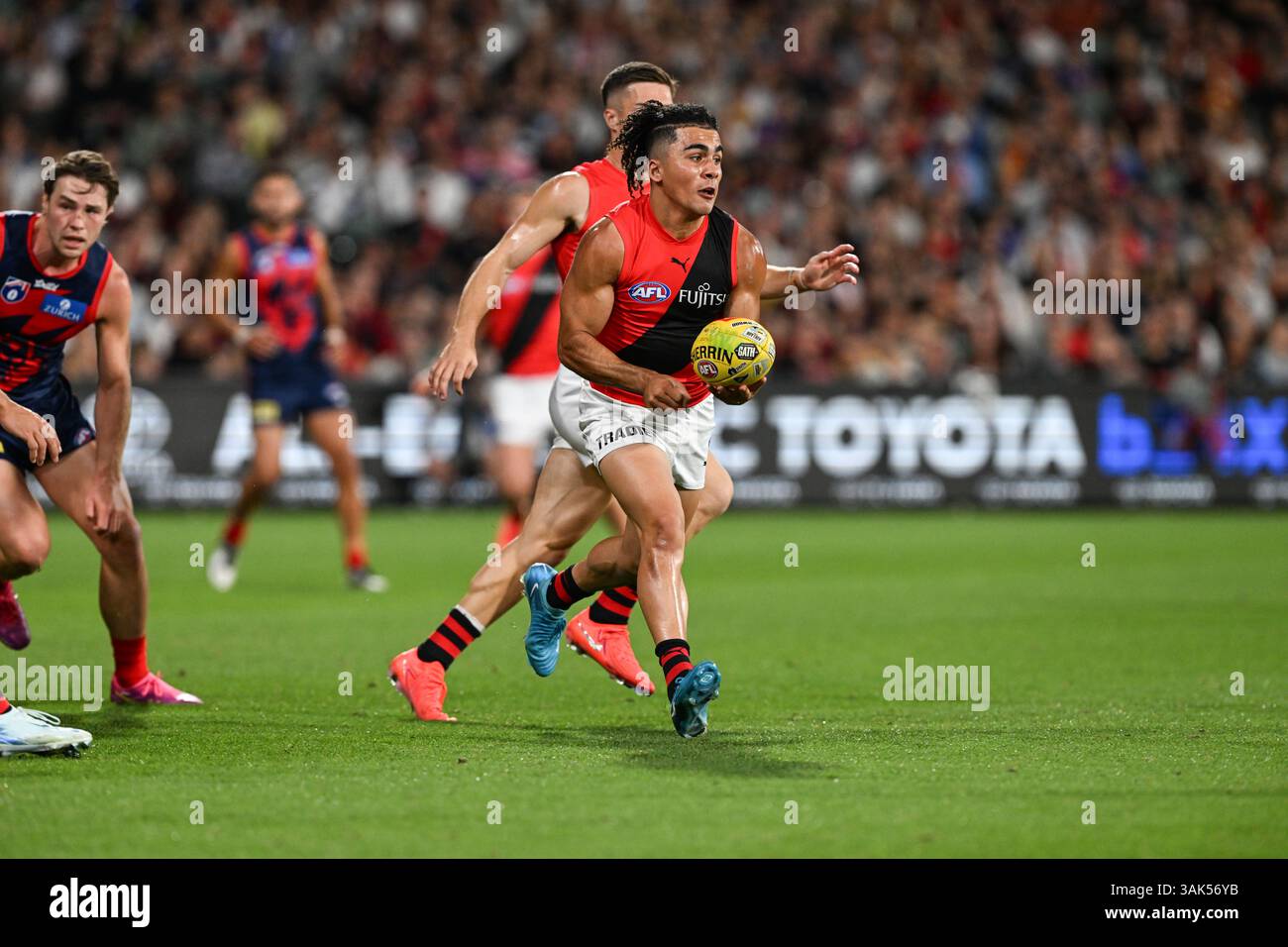 Isaac Kako of Essendon handballs during the AFL Round 5 match between ...