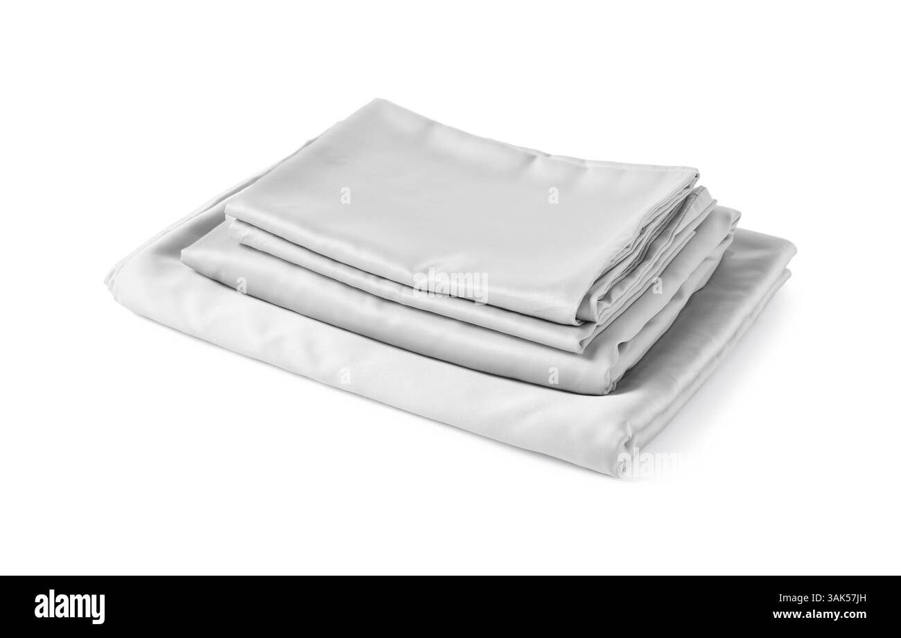 Stack of silky bed linens on white background Stock Photo - Alamy