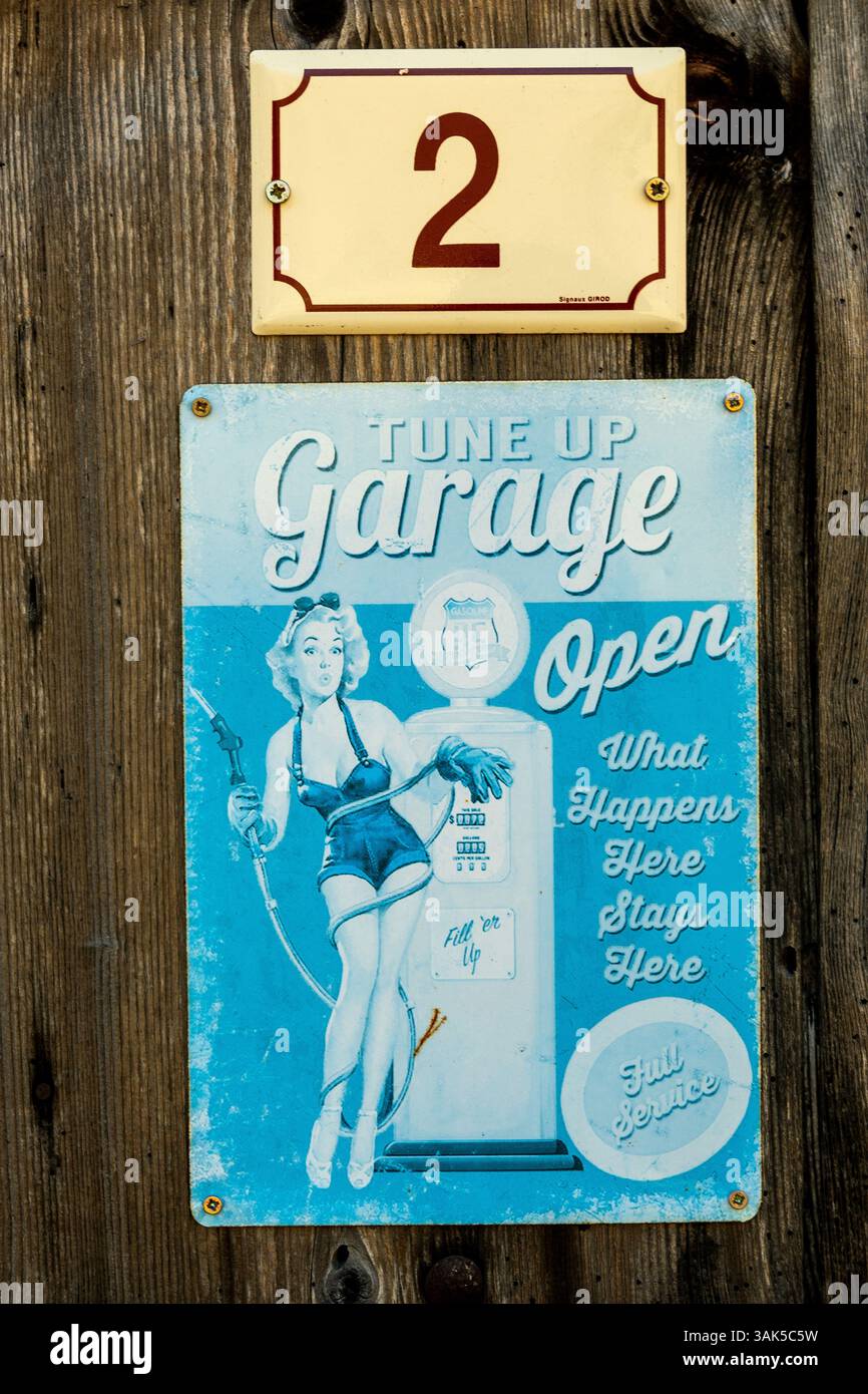 A nostalgic garage sign displays a classic design with a feminine ...