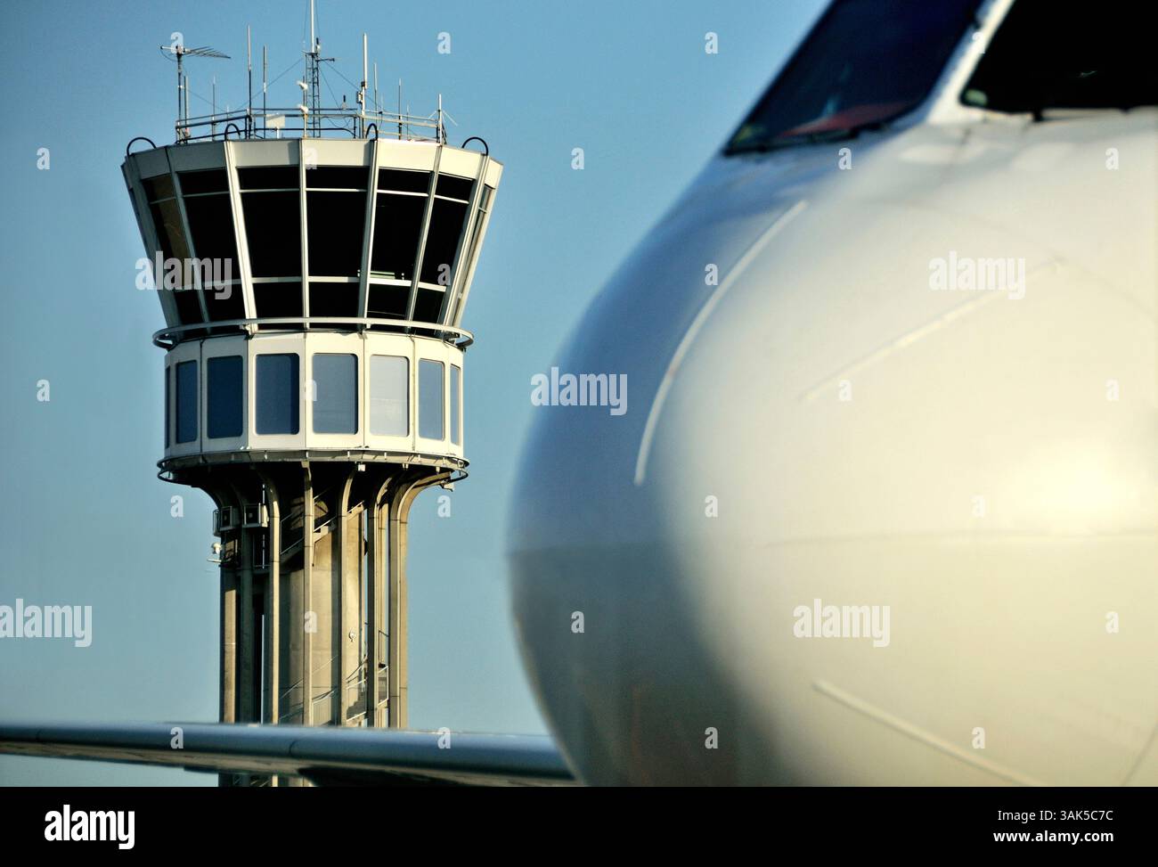 A close-up view of an airplane nose cone and the control tower at Saint ...