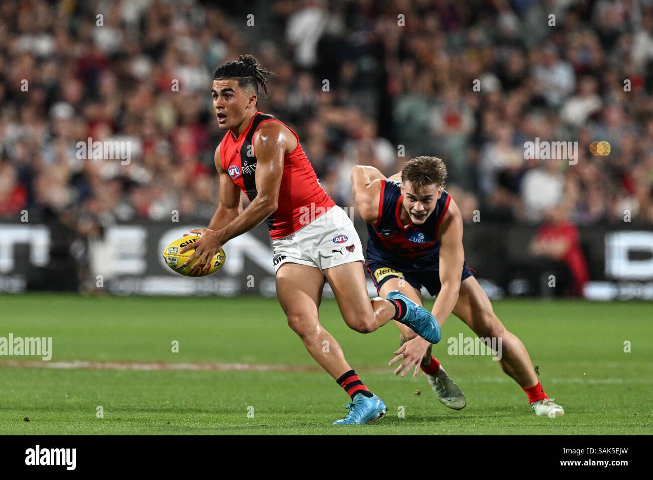 Adelaide, Australia. 12th Apr, 2025. Isaac Kako of Essendon clears away ...