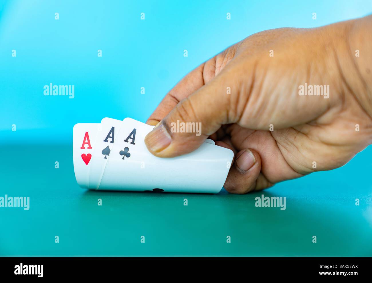 Close up hand flip playing card on aqua background, concept of take a ...
