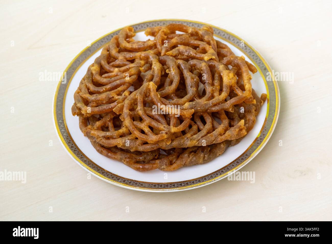 Delicious Shahi jilapi or jalebi on a white ceramic plate. It is a ...