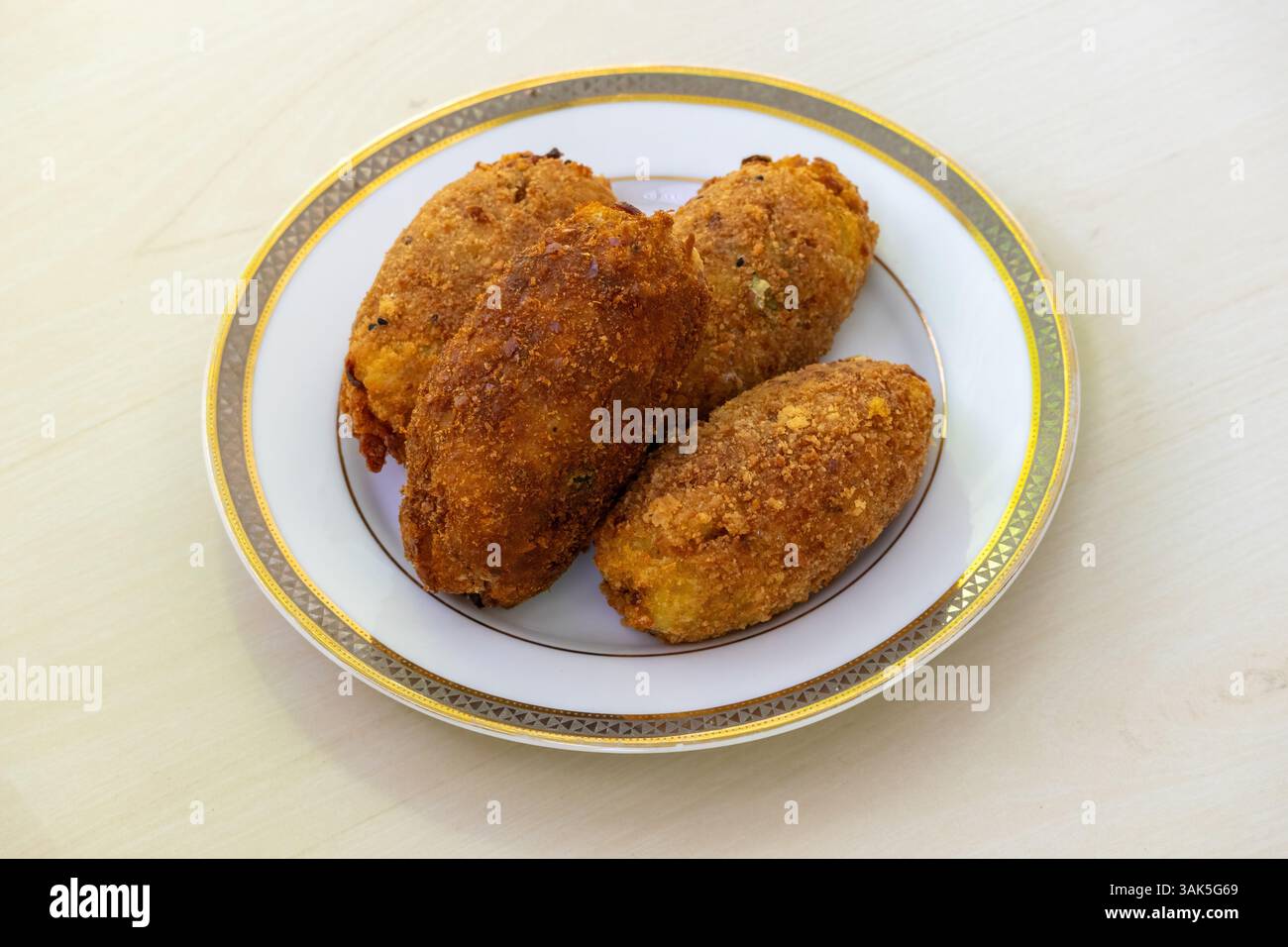 Tasty homemade dimer chop on a white plate, set against a light wooden ...