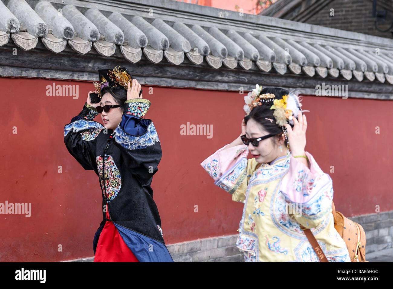 Beijing, China. 12th Apr, 2025. People walk on a street in Beijing ...