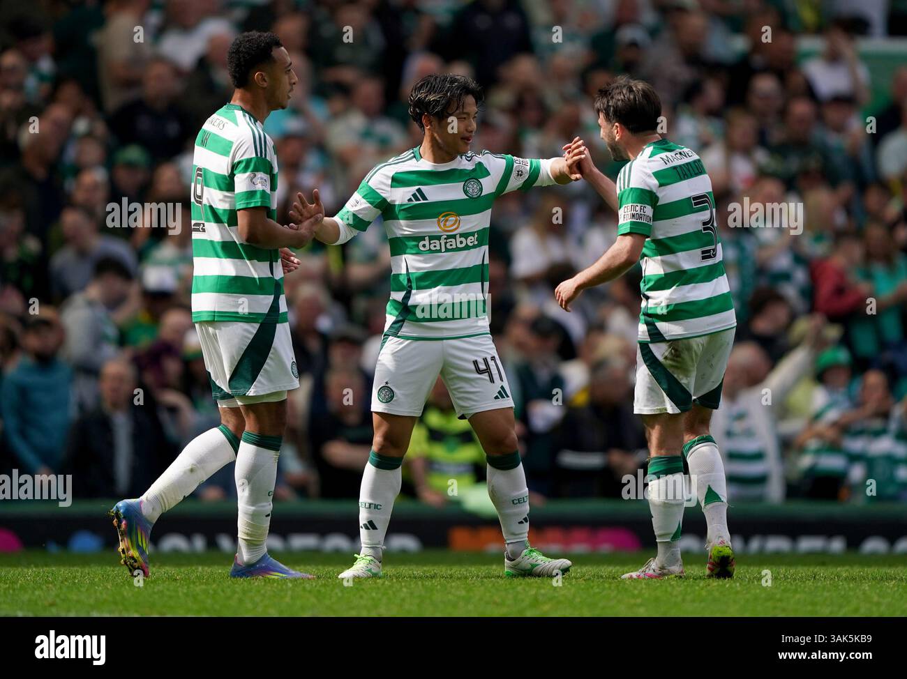 Celtic's Reo Hatate (centre) celebrates scoring his second goal and his ...