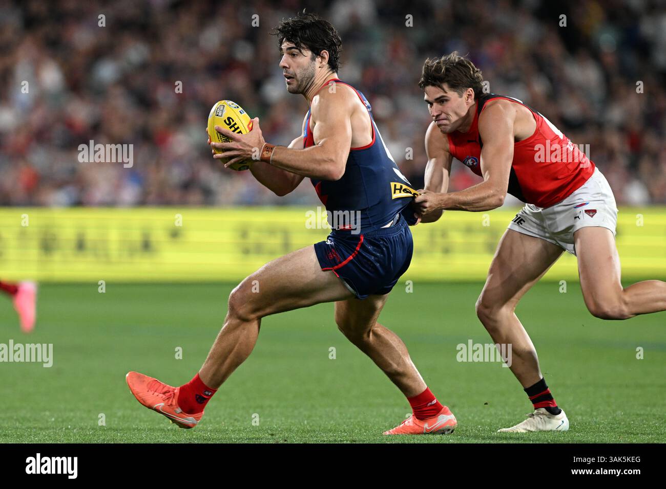 Christian Petracca of Melbourne tackled by Sam Durham of Essendon ...
