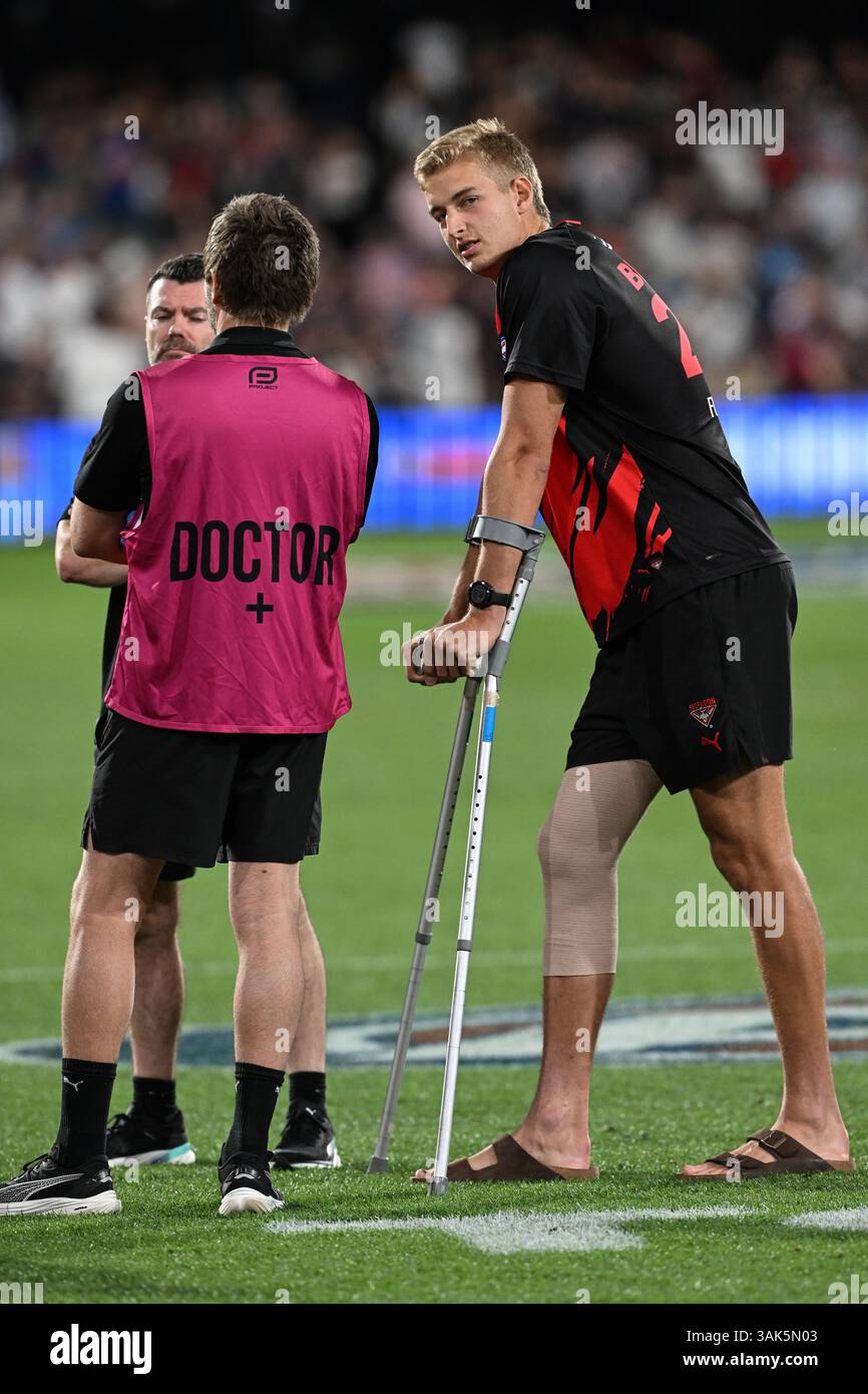 Nick Bryan of Essendon with the club doctor during the AFL Round 5 ...