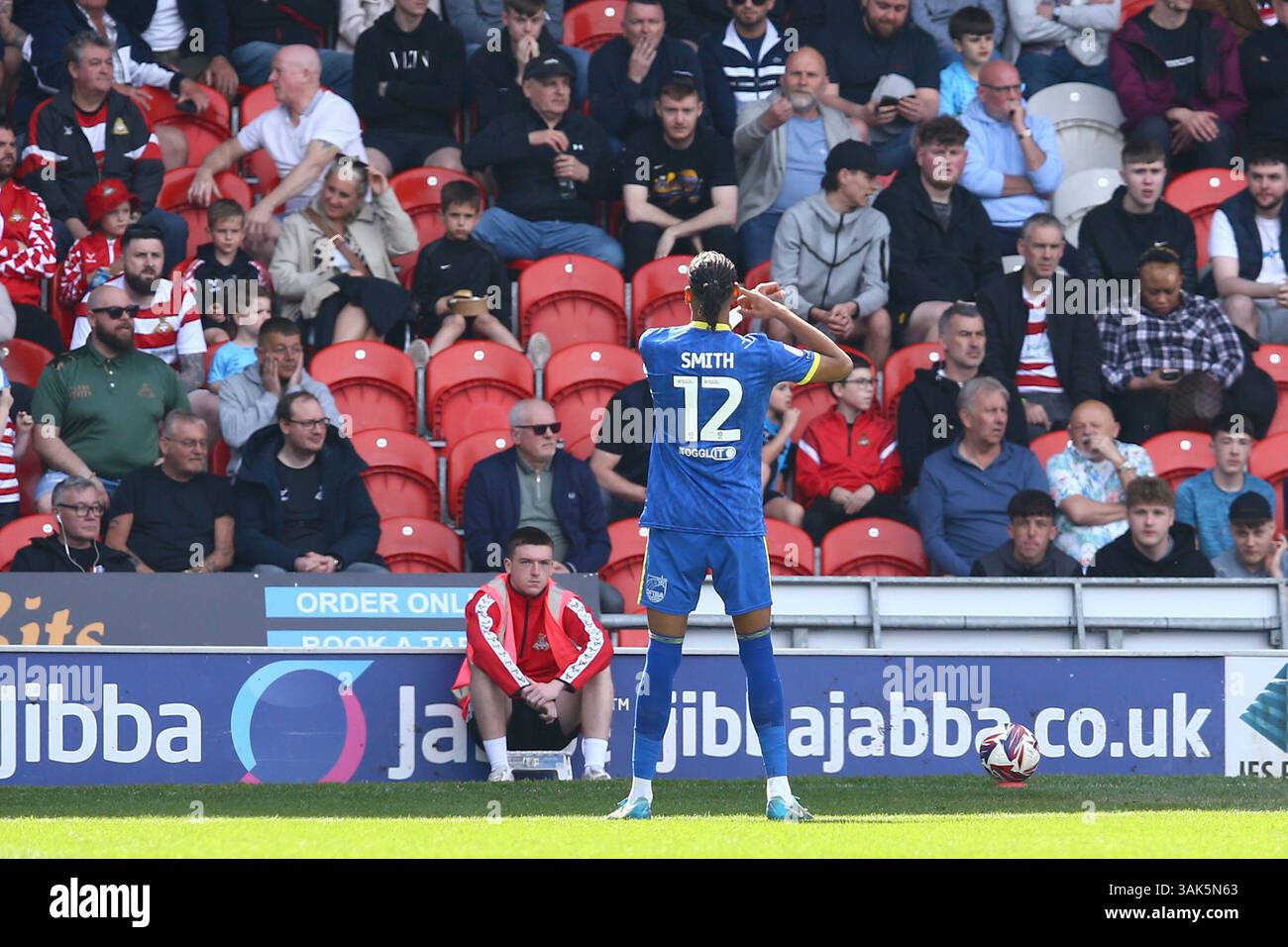 Eco - Power Stadium, Doncaster, England - 12th April 2025 Alistair Smith (12) of AFC Wimbledon ...