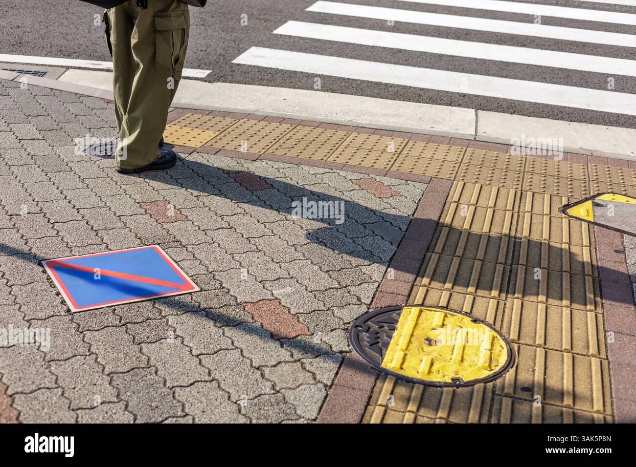 Person walking on tactile paving hi-res stock photography and images ...