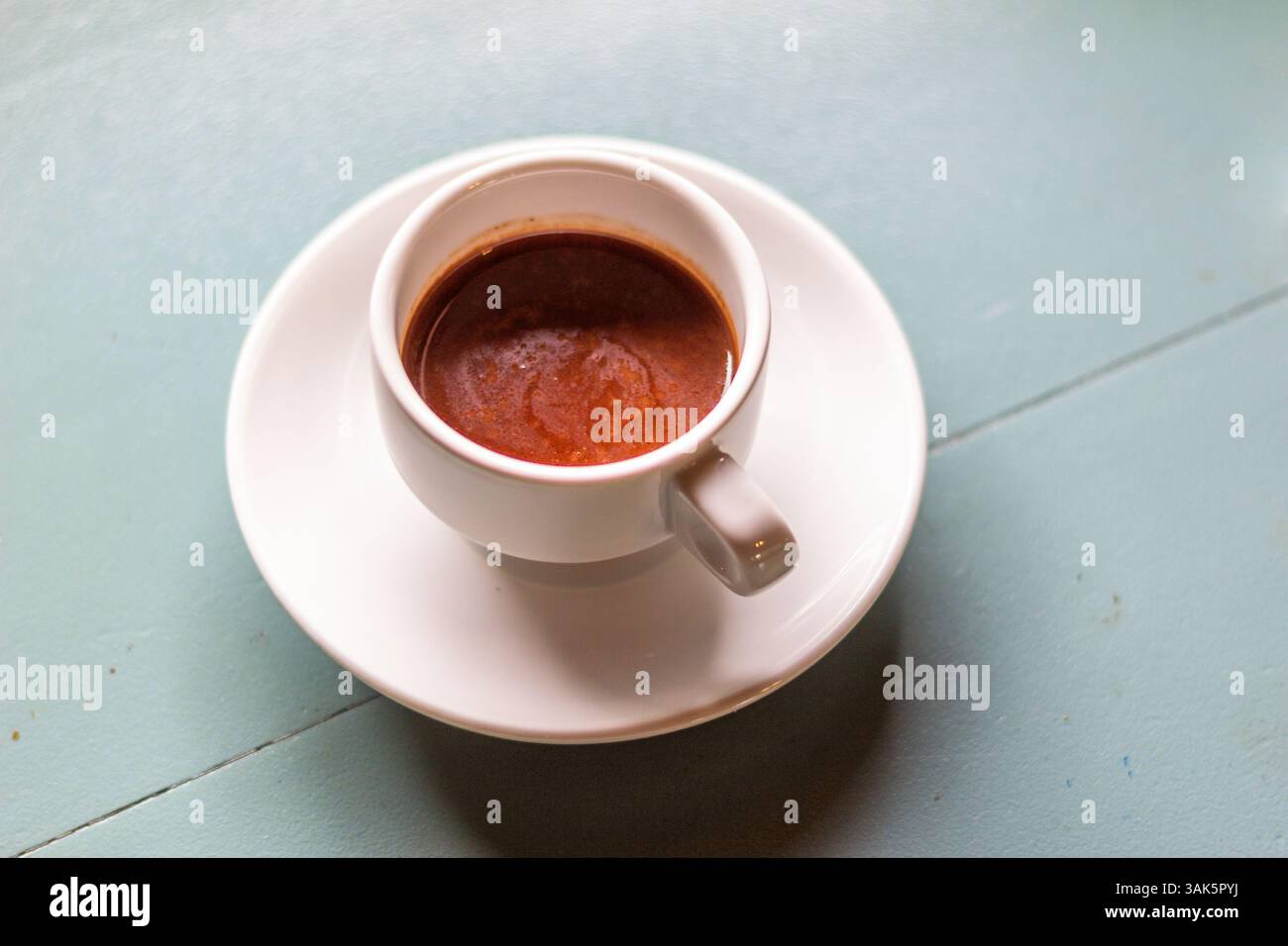 A cup of traditional Filipino thick hot chocolate drink served inside ...