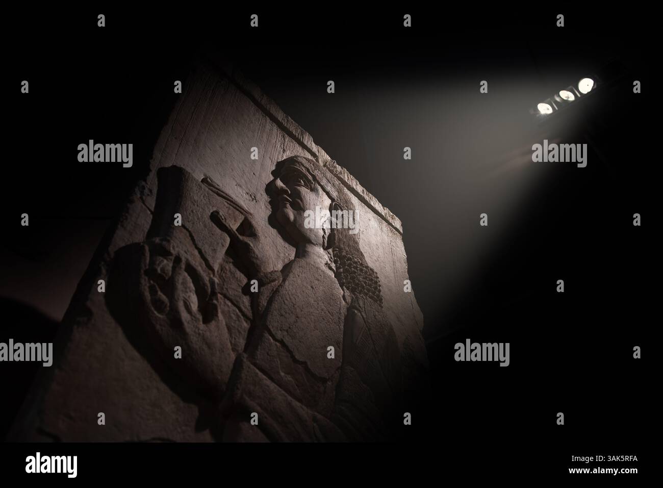 Ancient Assyrian stone relief illuminated in dramatic lighting, Iraq ...