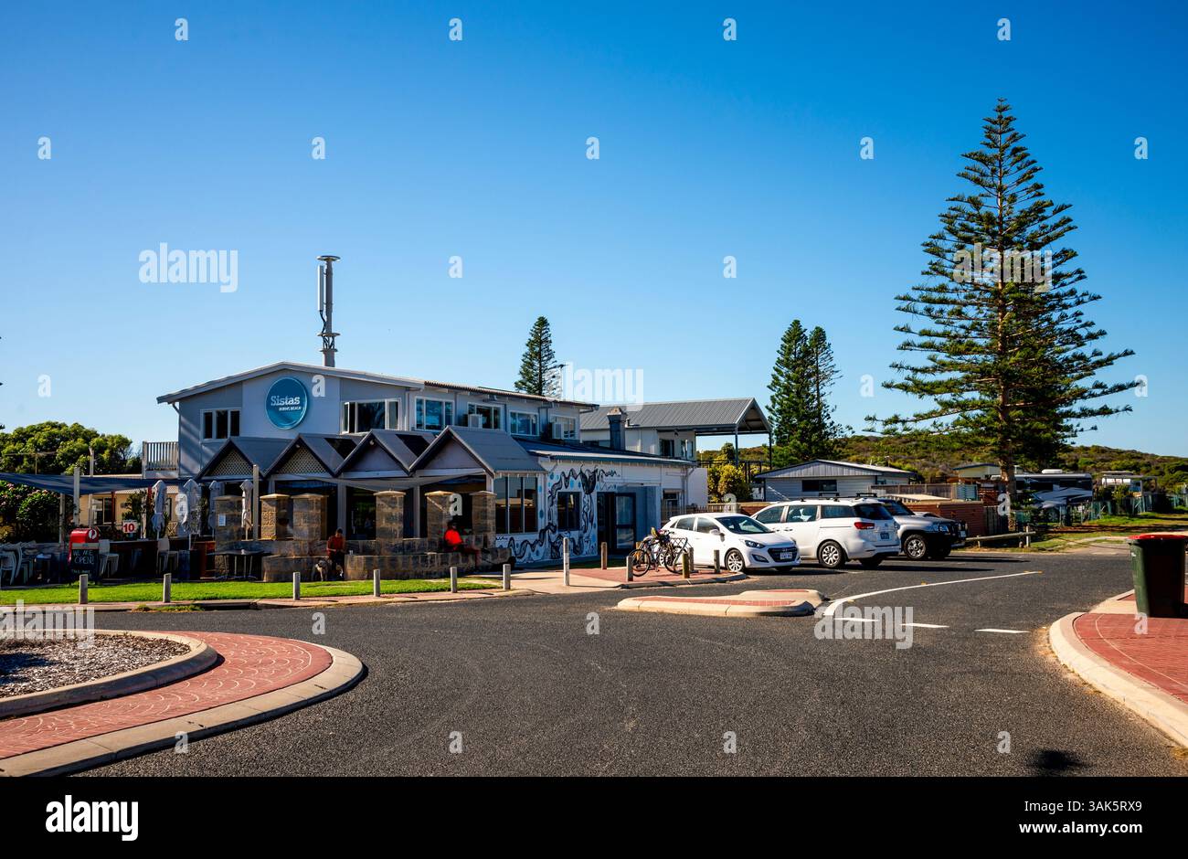 Coastal Cafe and Restaurant Exterior Under Clear Sky with Parking Lot ...