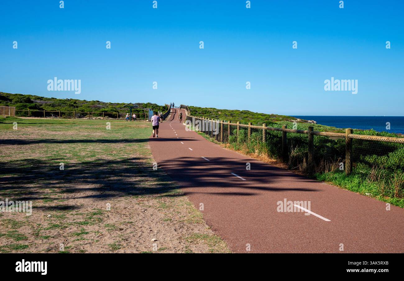 Pathway Along Scenic Coastline with People Strolling on a Sunny Day at ...