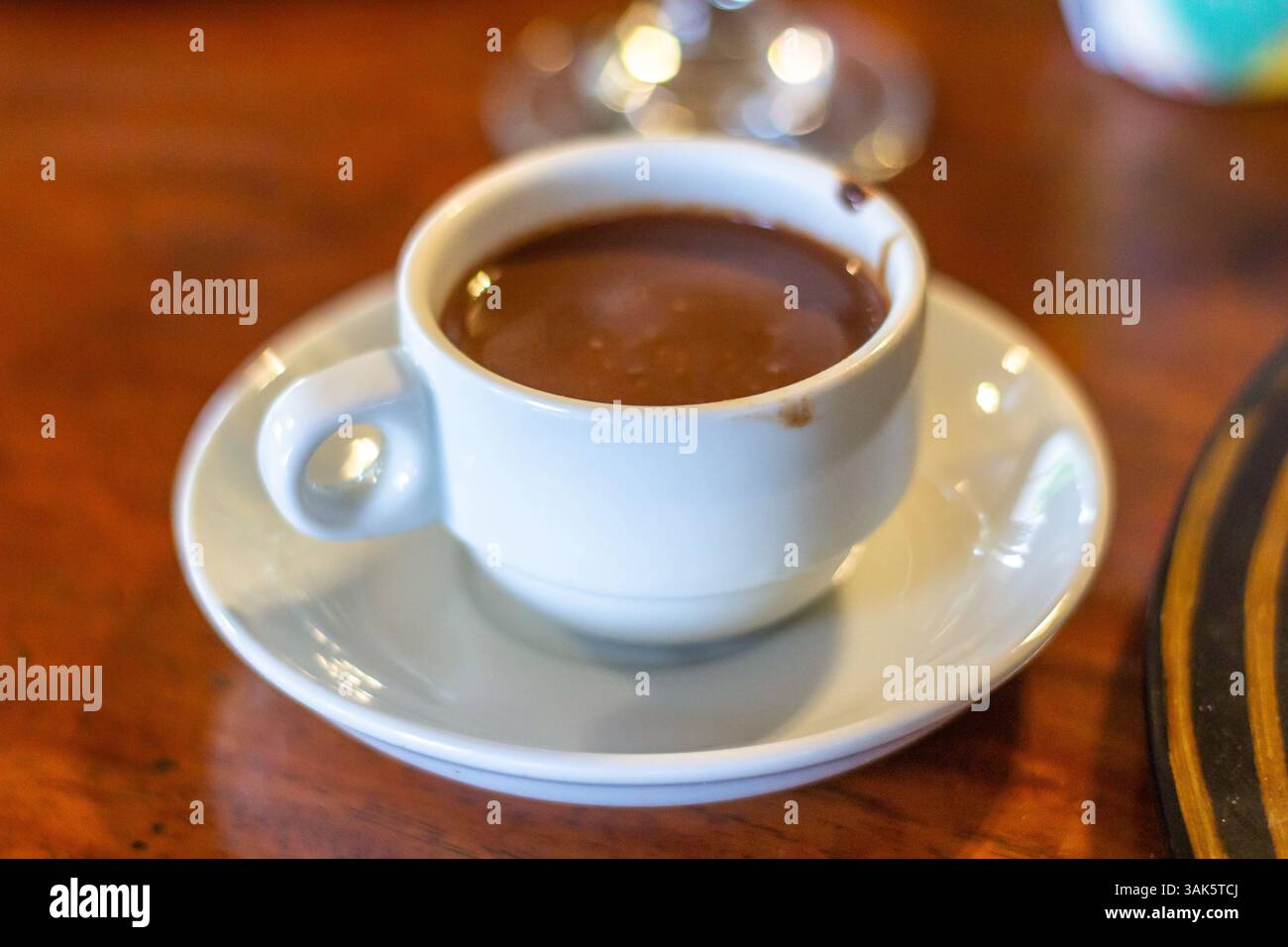 A cup of traditional Filipino thick hot chocolate drink served inside ...