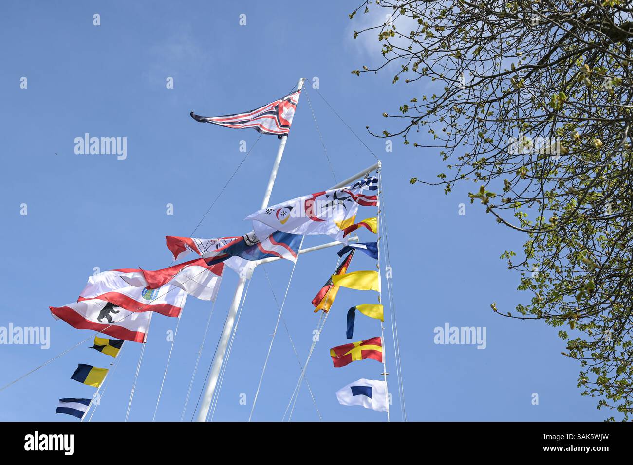 Zeuthen, Germany. 12th Apr, 2025. Flags fly on a flagpole. This year ...